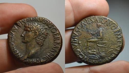 Nero Claudius Drusus AE sestertius - Claudius seated on weapons