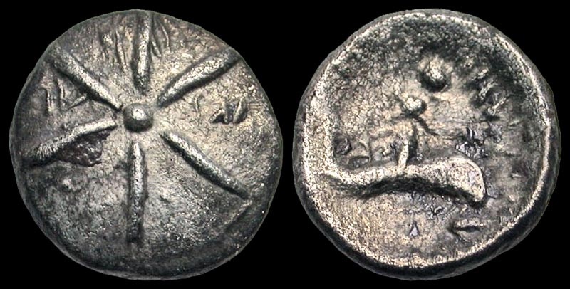 British Celtic silver coin - star with six rays / boy riding dolphin ...