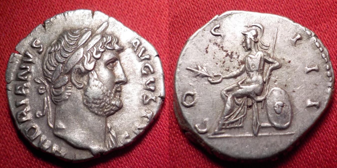 HADRIAN AR silver denarius. Roma seated left, holding branch, shield at ...