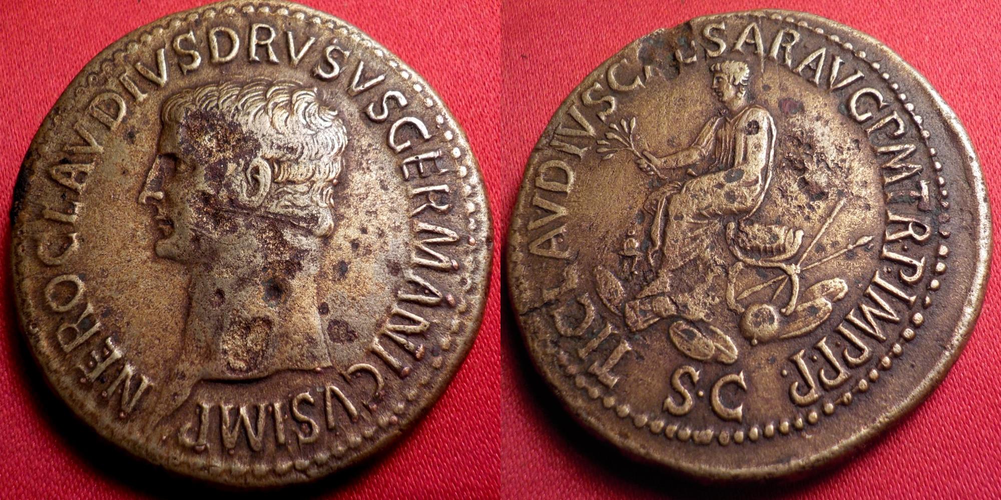 NERO CLAUDIUS DRUSUS AE sestertius. Claudius seated, scattered arms at ...