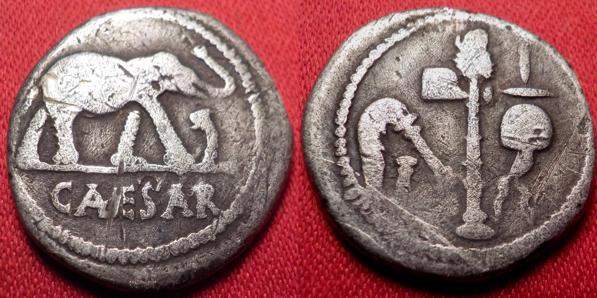JULIUS CAESAR AR silver denarius. Elephant trampling serpent. Four ...
