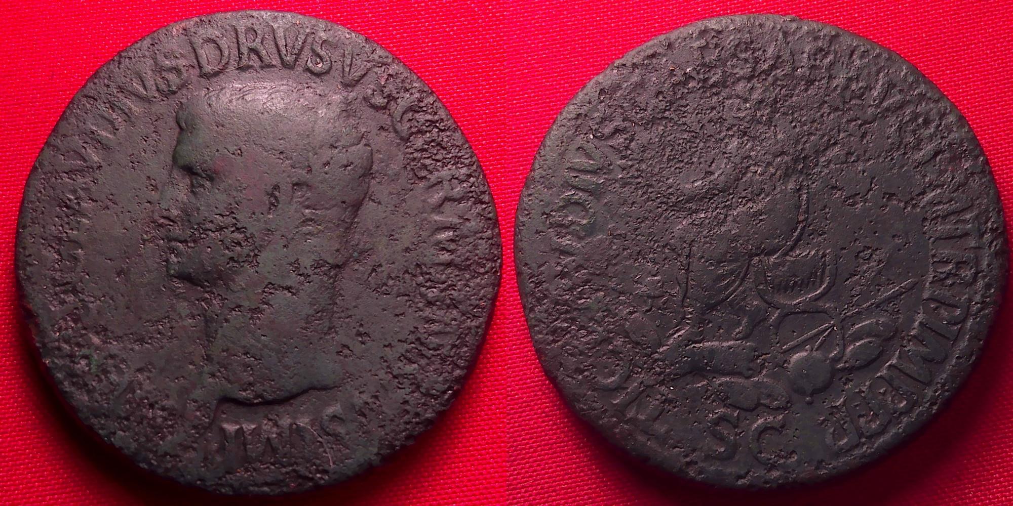NERO CLAUDIUS DRUSUS AE sestertius. Claudius seated, scattered arms at ...